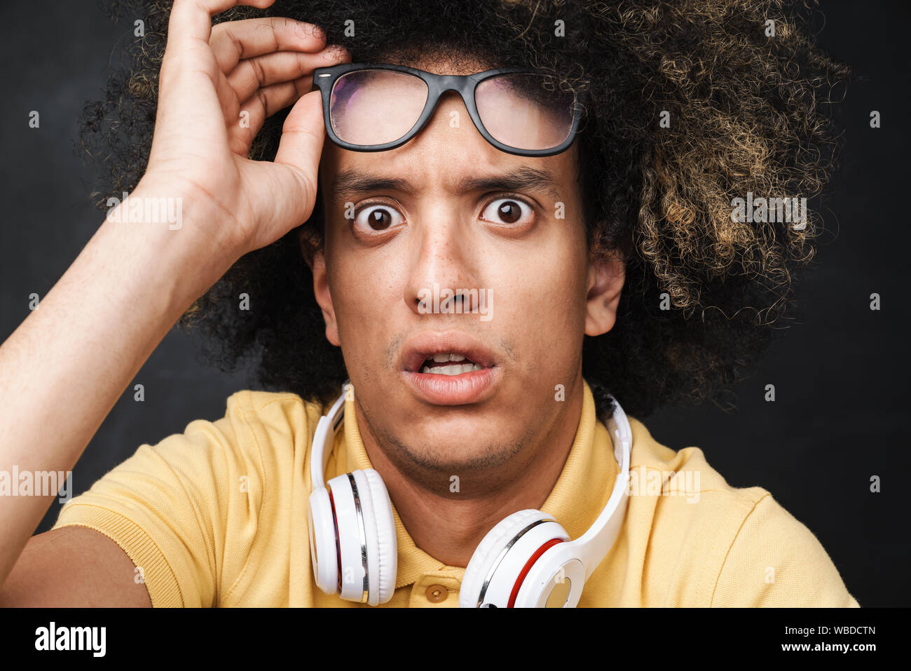 Portrait of a young emotional shocked scared teenage guy posing over ...