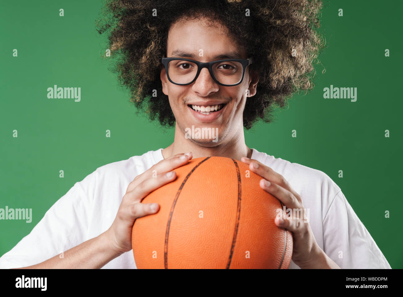Portrait closeup of young happy man with afro hairstyle holding ...