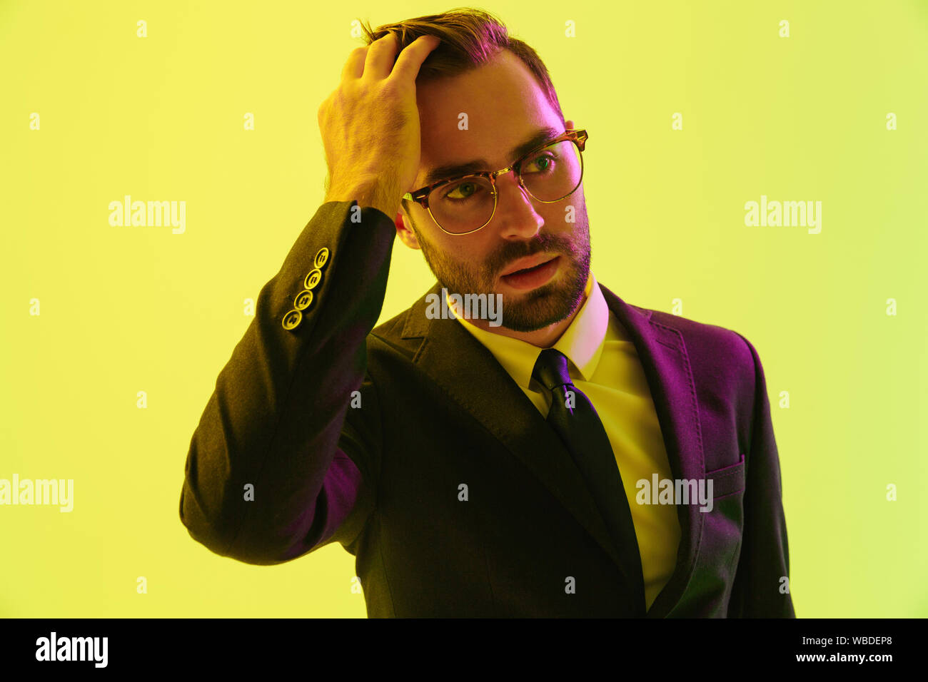 Picture of a handsome serious business man posing isolated over light ...