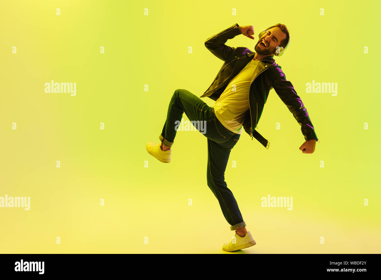 Image of emotional handsome young stylish man jumping dancing isolated ...