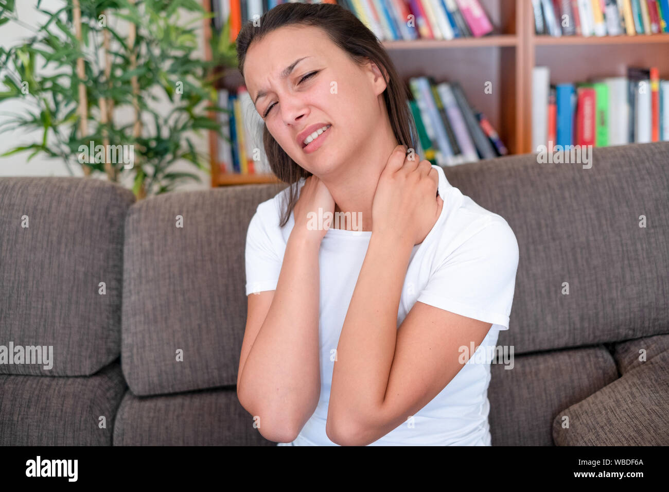 Backache woman sofa hi-res stock photography and images - Alamy