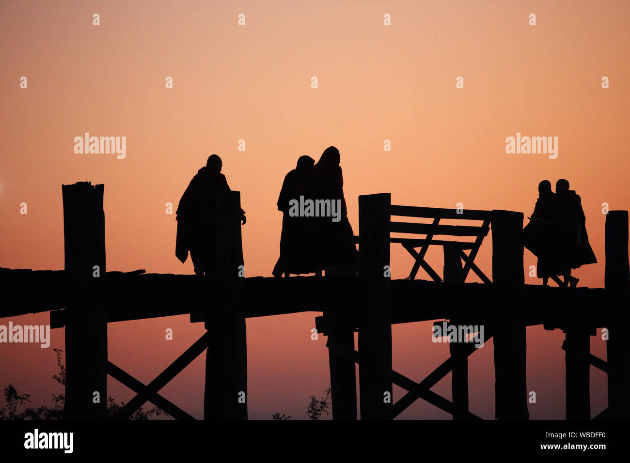 Monks crossing the U-Bein bridge at sunset, Amarapura, Myanmar (Burma ...