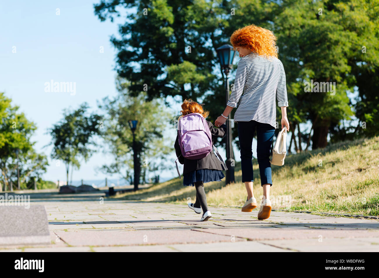 Happy child going home with her mommy Stock Photo - Alamy