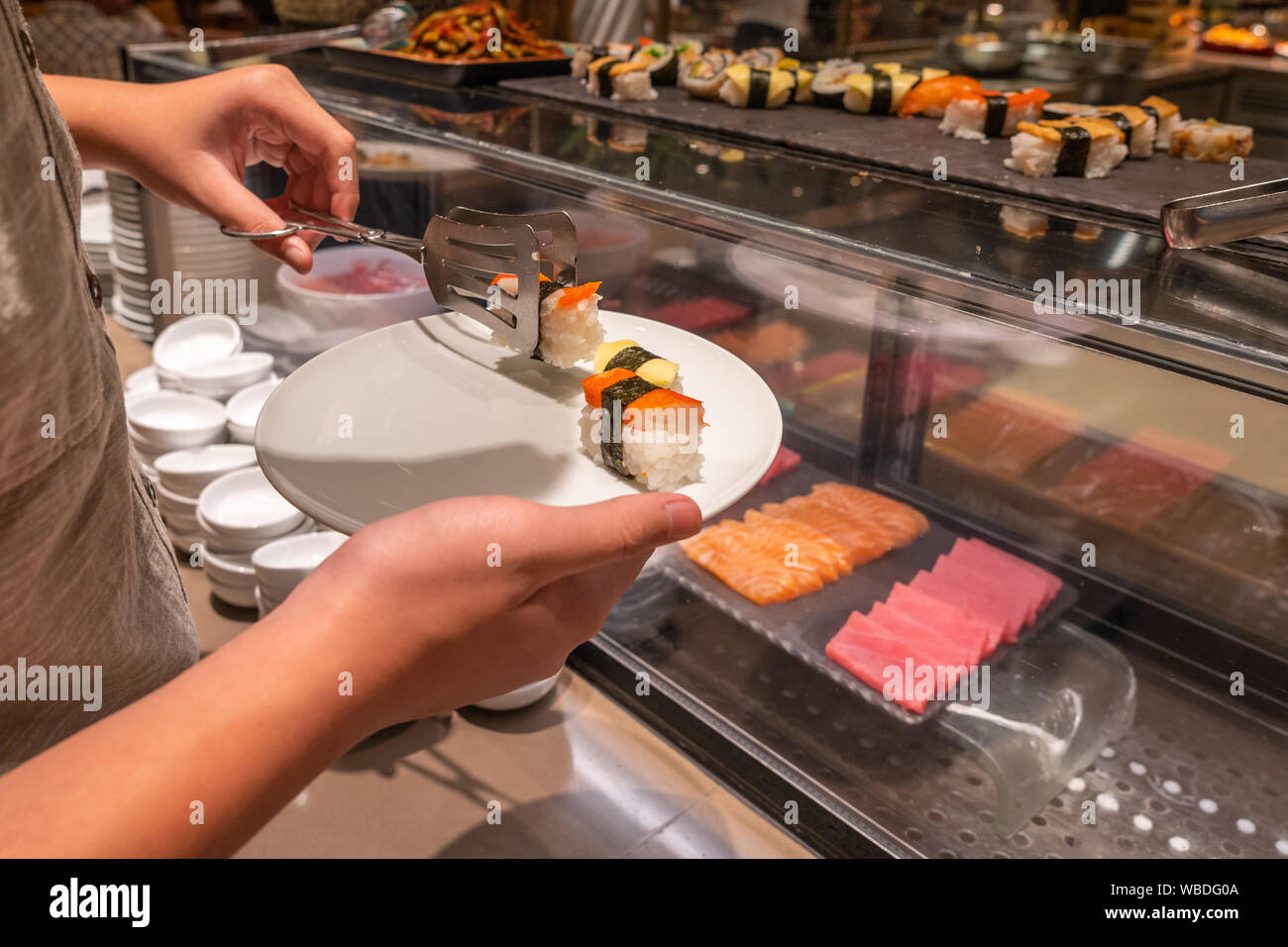 Human hands holding plate sushi hi-res stock photography and images - Alamy