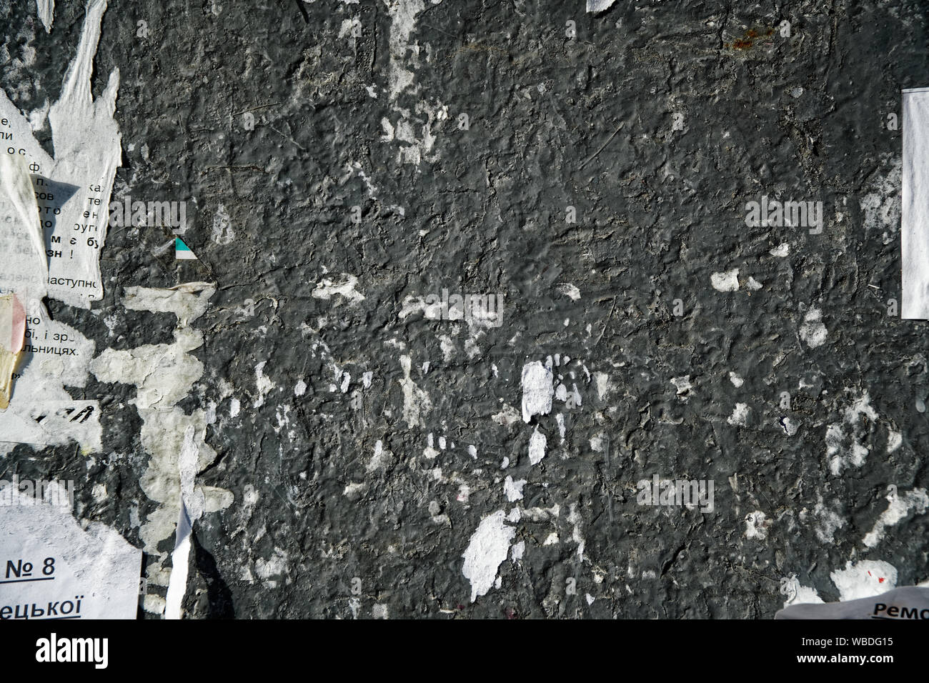 Torn poster, plastered wall with exposed brick wall Stock Photo - Alamy