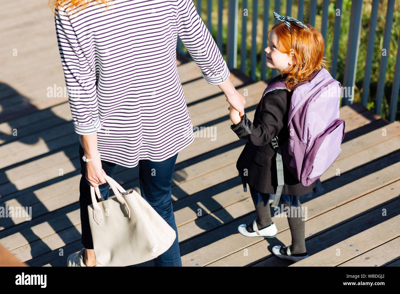 Positive delighted red haired girl going downstairs Stock Photo - Alamy