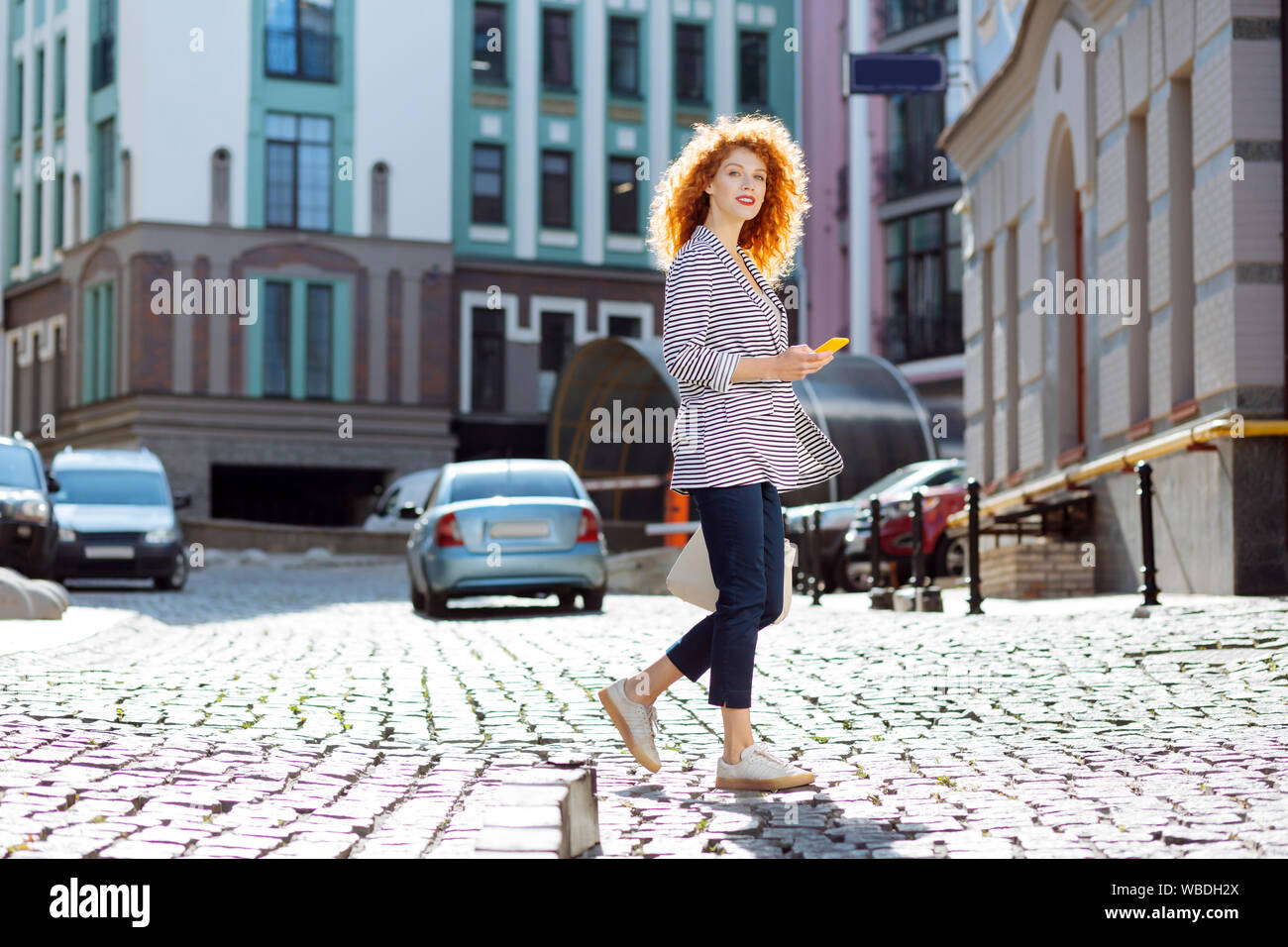 Joyful young female going home after meeting Stock Photo - Alamy