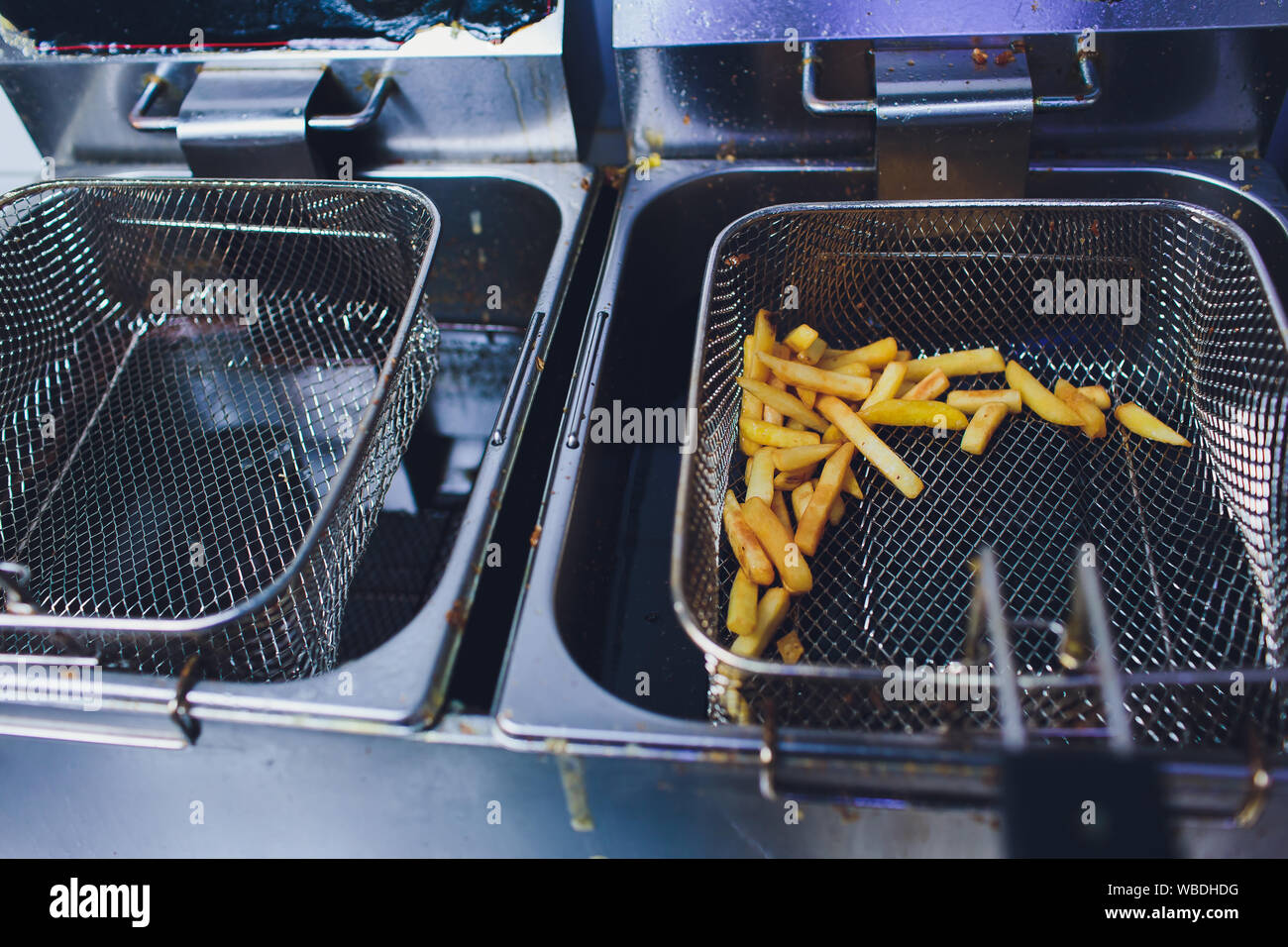 Female chef preparing french fries in kitchen Stock Photo - Alamy