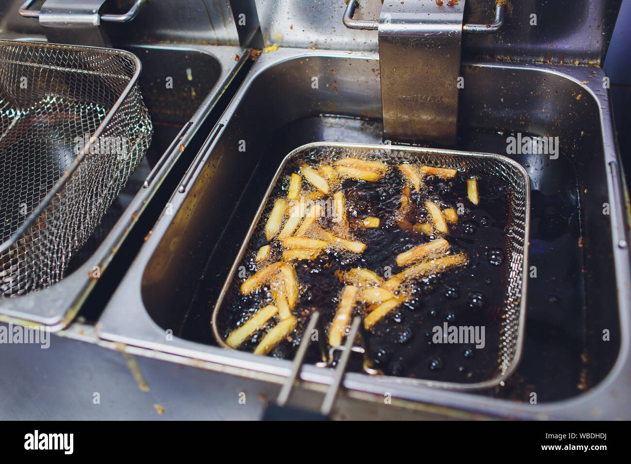 Female chef preparing french fries in kitchen Stock Photo - Alamy