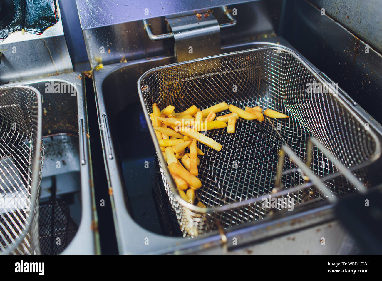 Female chef preparing french fries in kitchen Stock Photo - Alamy