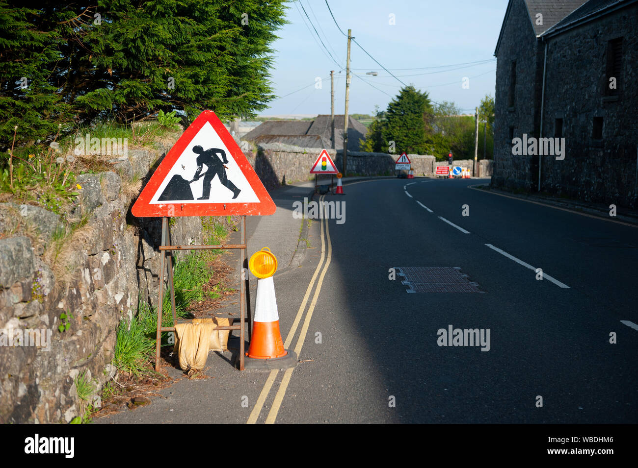 Road work signs in UK village Stock Photo - Alamy
