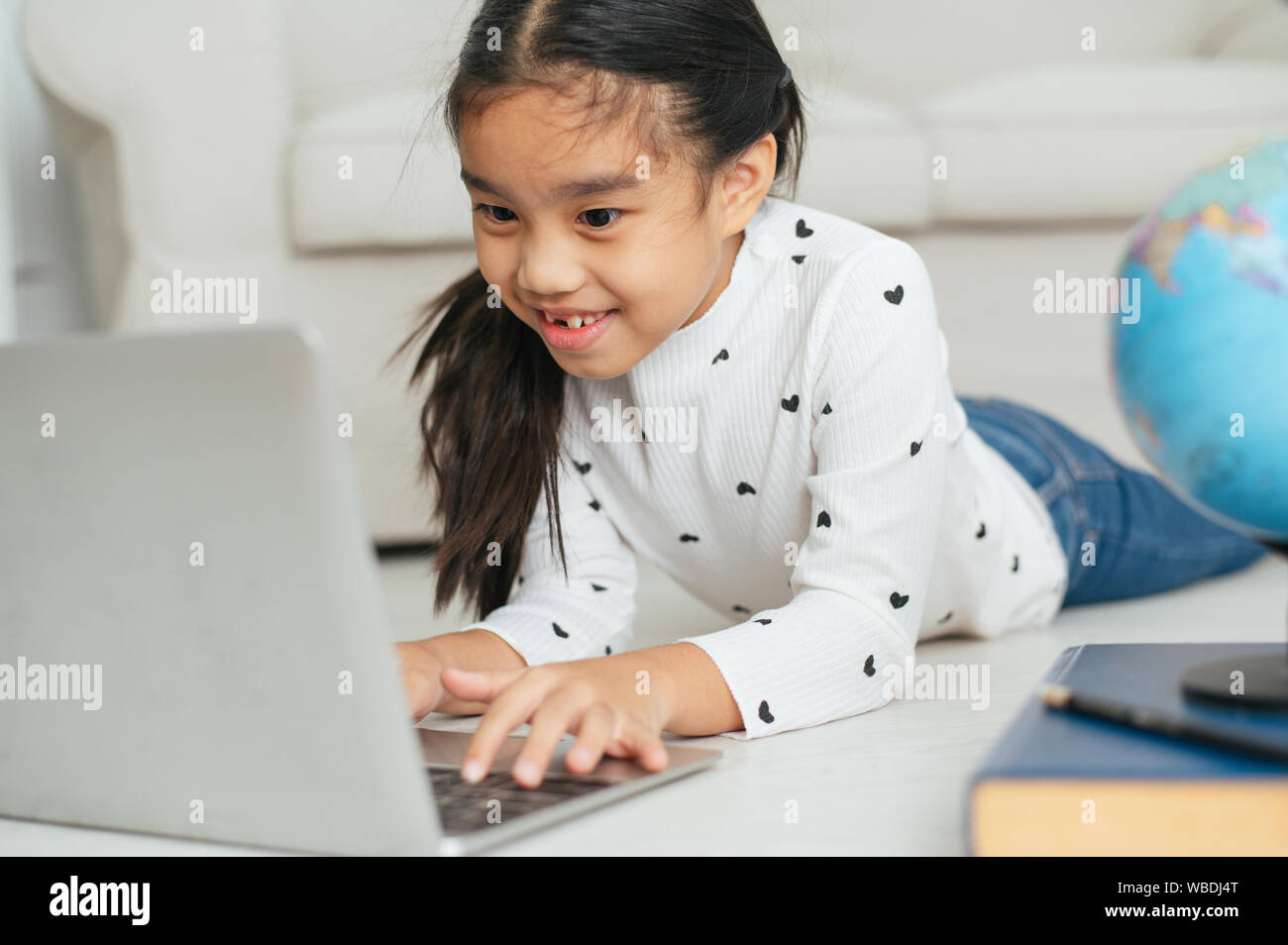 Happy Asian girl using laptop computer, concept for kid's art and home ...