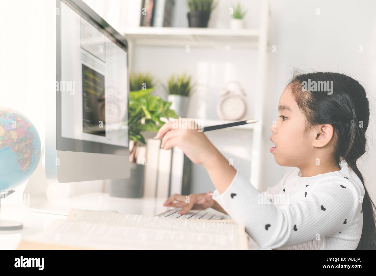 happy beautiful little girl student using mobile pad computer studying ...