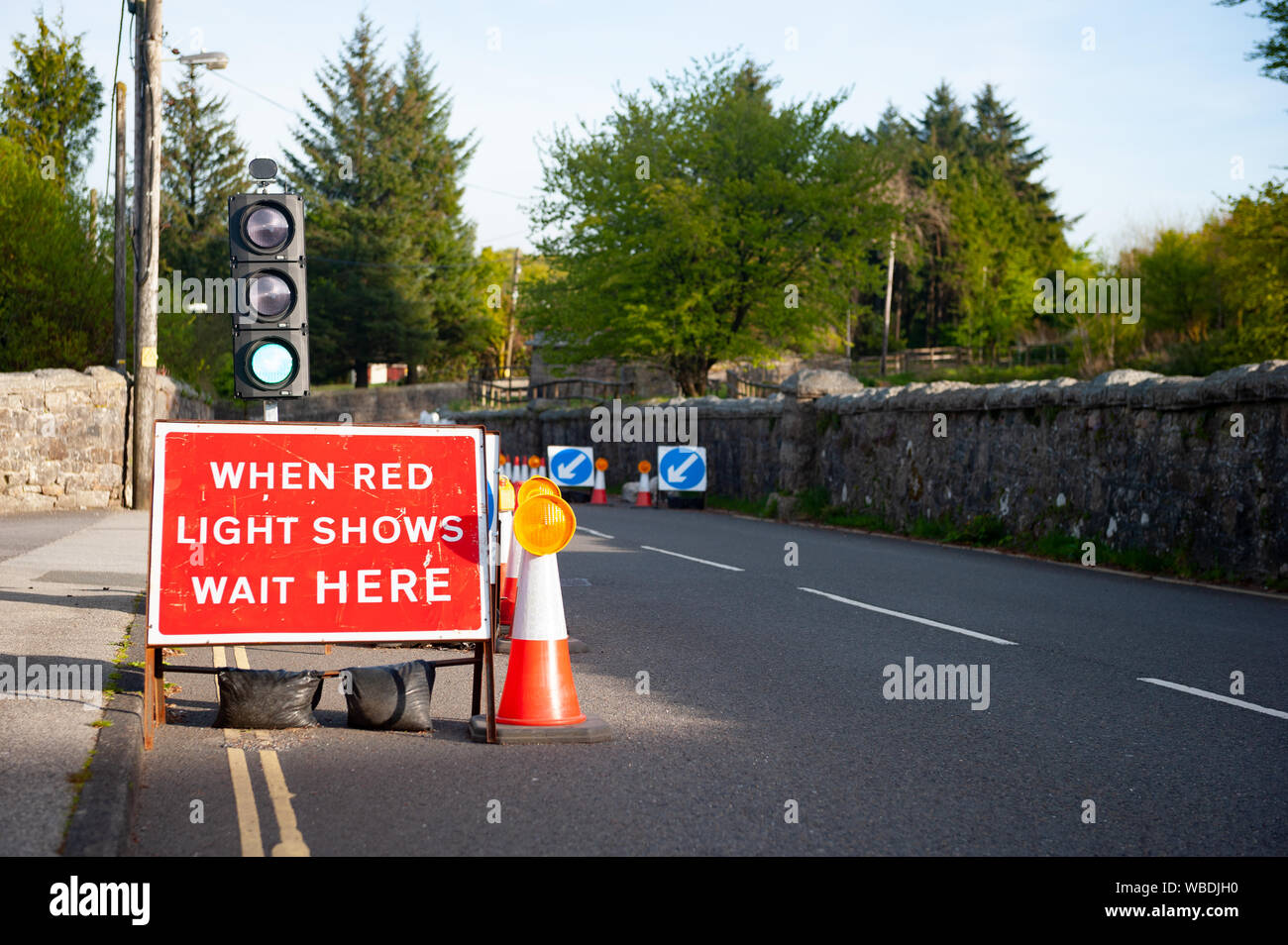 Road work signs in UK village Stock Photo - Alamy