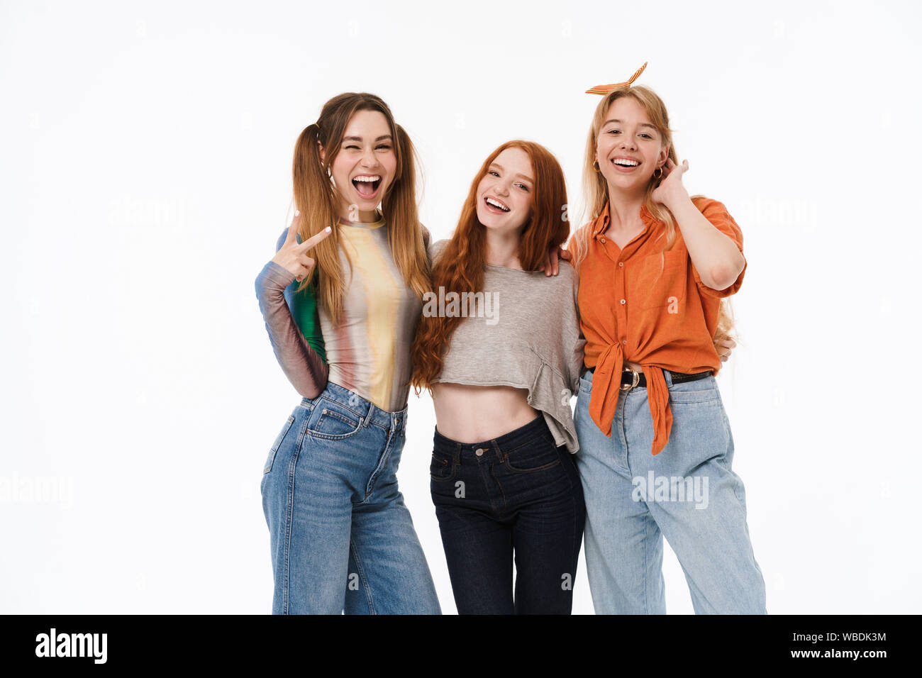 Portrait of three beautiful girls wearing casual clothes smiling and ...