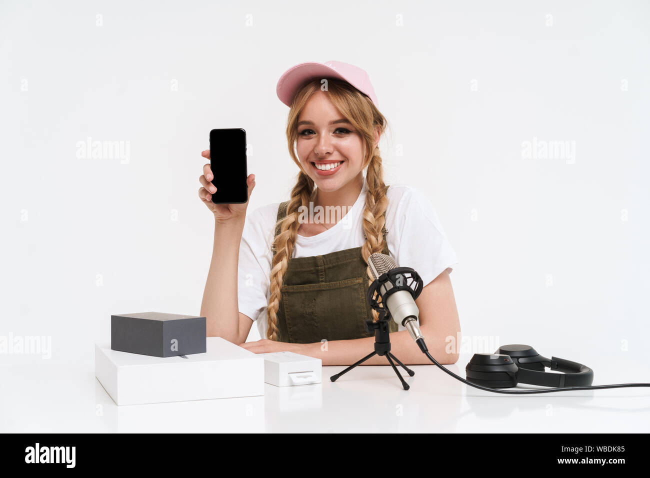 Cheerful young blonde girl vlogger making a video with different ...