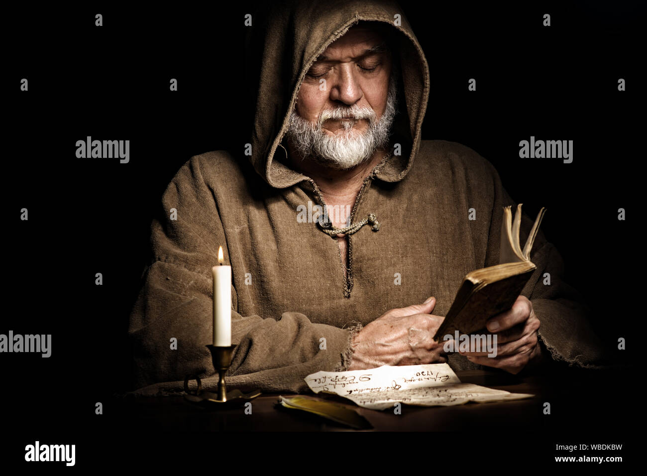Medieval monk pensive with book Stock Photo - Alamy