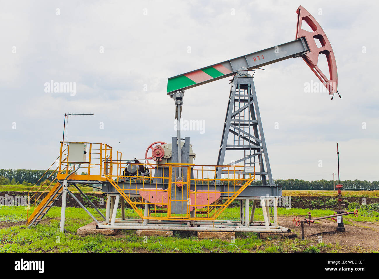 Oil production on the background of grass and sky Stock Photo - Alamy