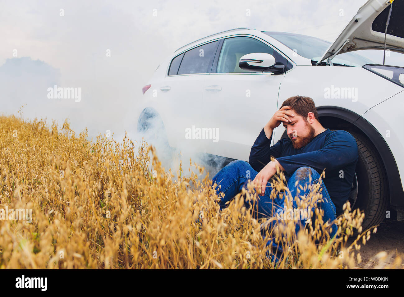 Stressed and frustrated driver pulling his hair while standing on the ...