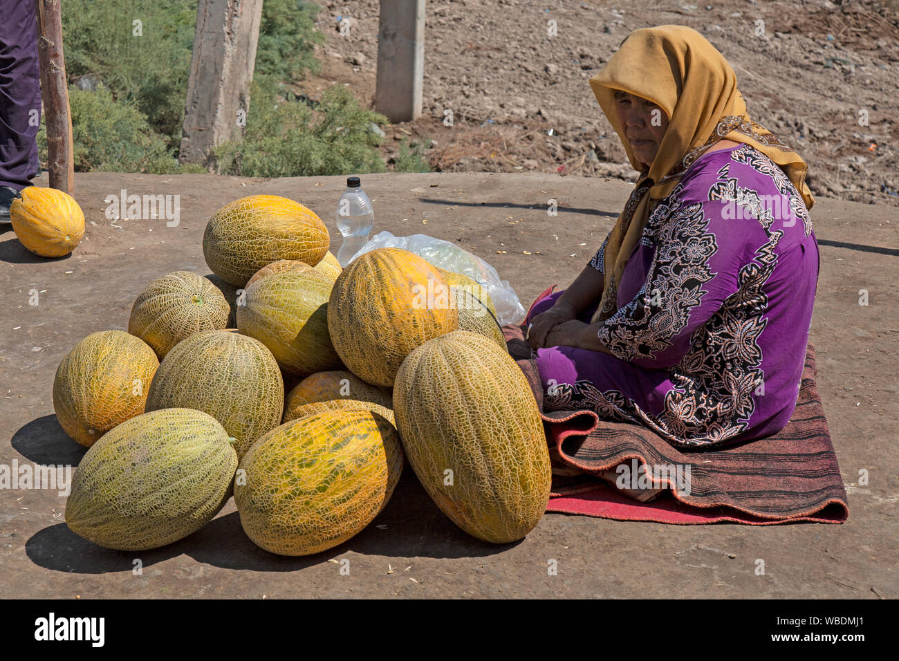 An elderly woman selling water melons on the street in Uzbekistan Stock ...