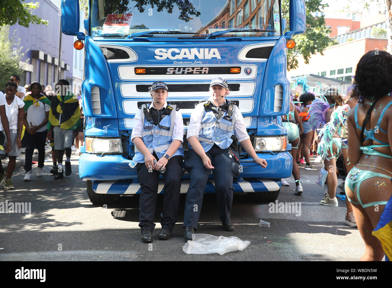 Police officers sit on the front of a lorry during the the Notting Hill ...