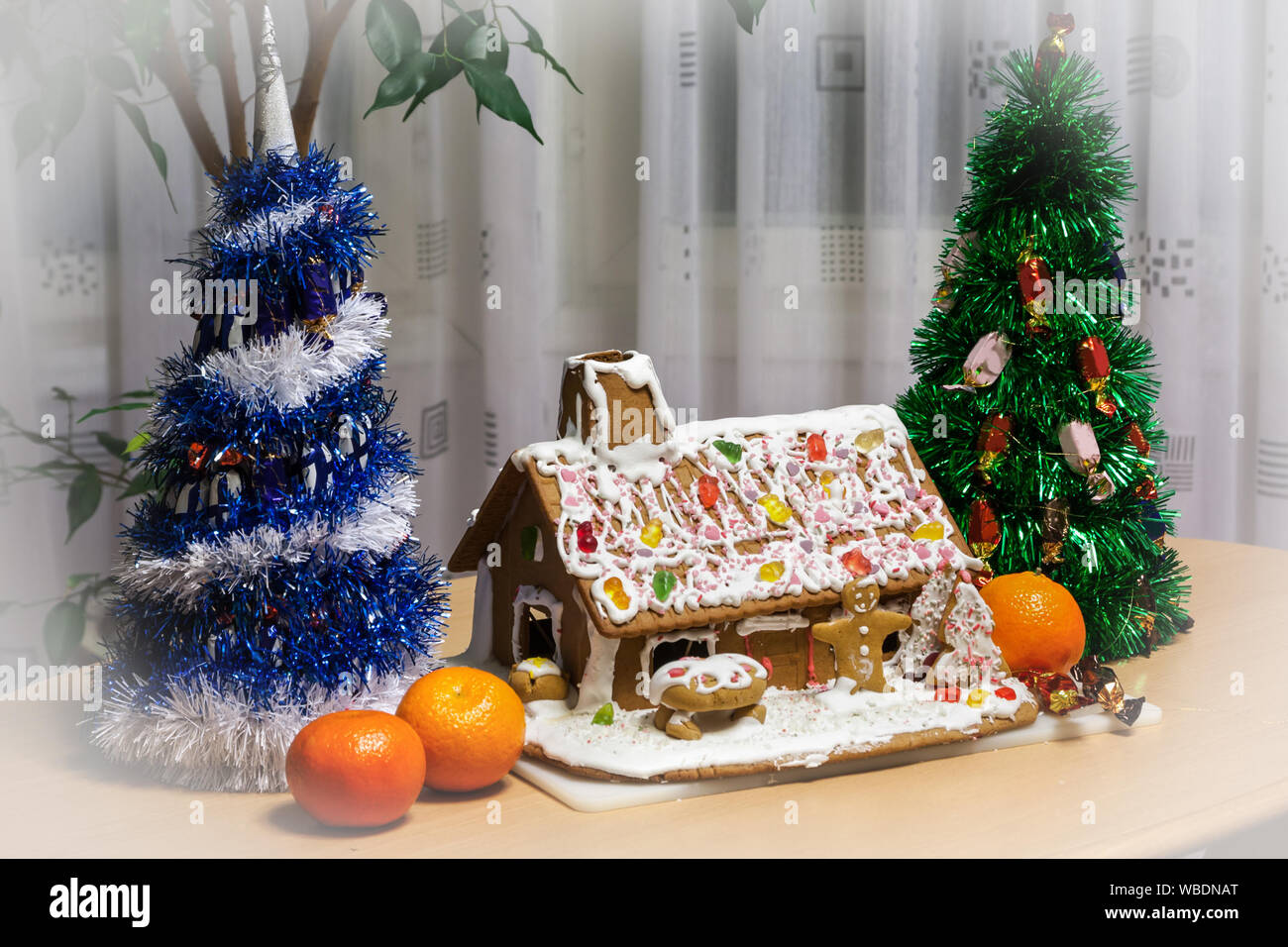 Christmas scene with trees and gingerbread house Stock Photo - Alamy