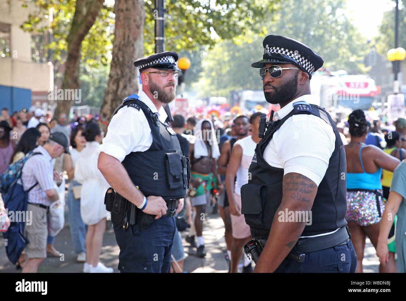 Police officers watch over the crowds of revelers during the the ...