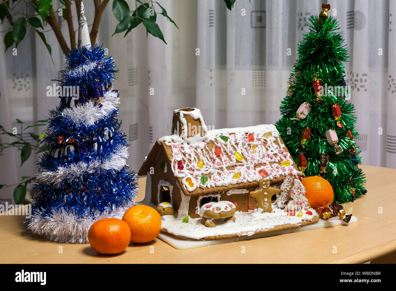 Christmas scene with trees and gingerbread house Stock Photo - Alamy