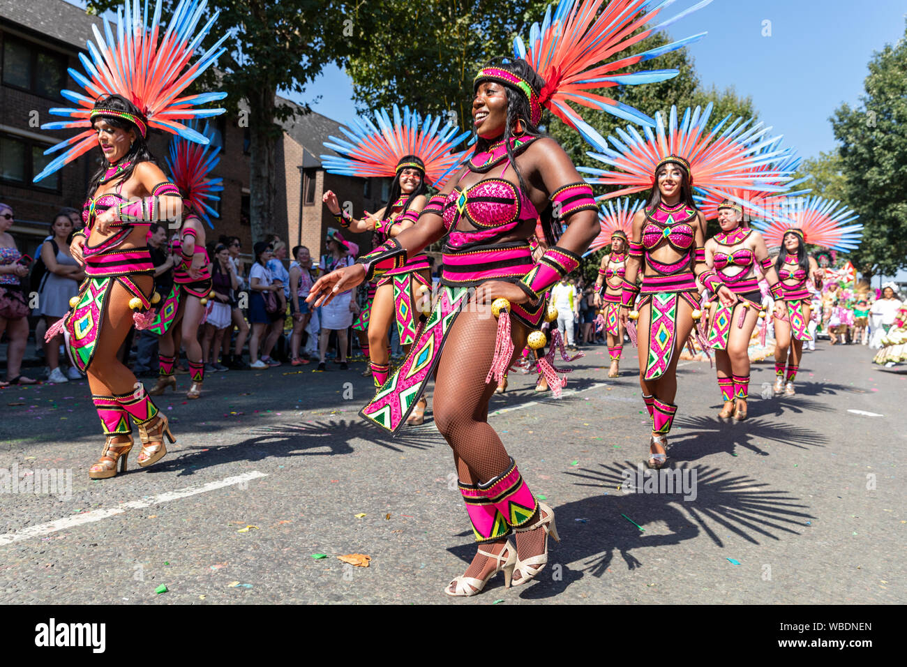 A carnival troupe performing on a city street, in Westbourne Park ...