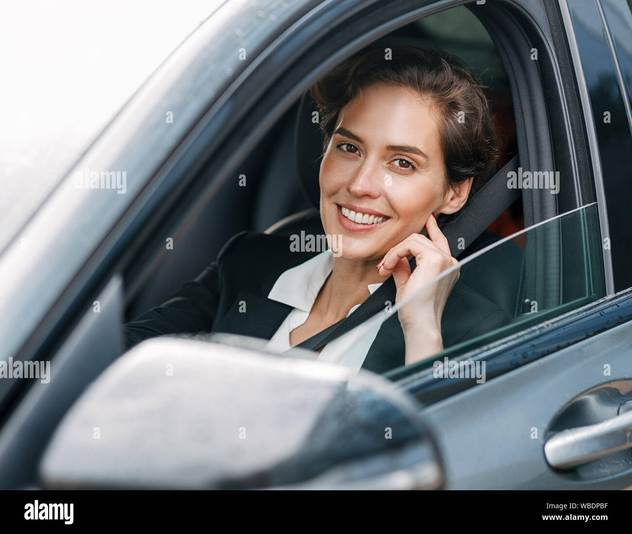 Beautiful business lady looking at camera. Young woman looking out of ...