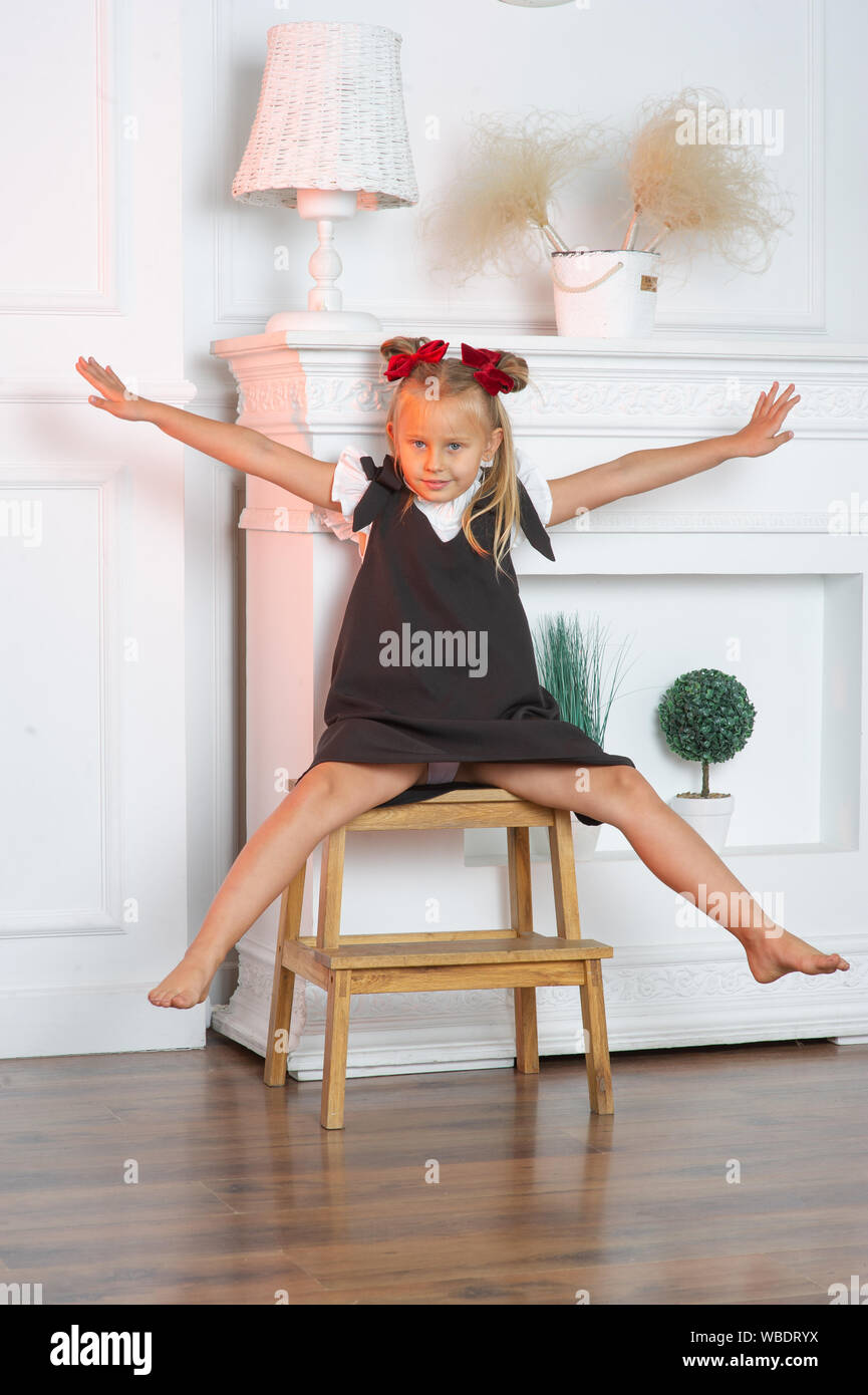 Portrait of beautiful young first-grader. First-grader girl in the ...