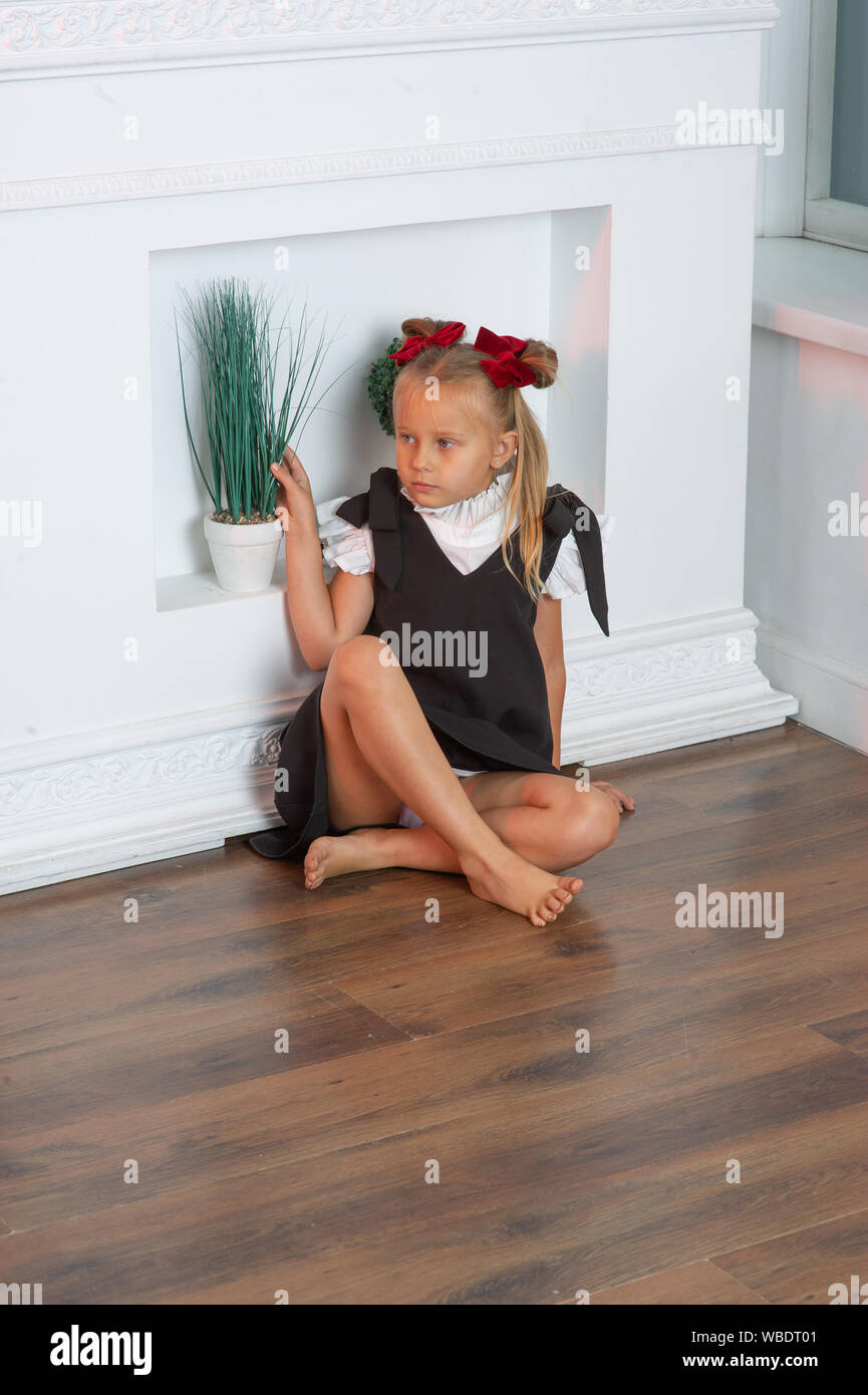 Portrait of beautiful young first-grader. First-grader girl in the ...