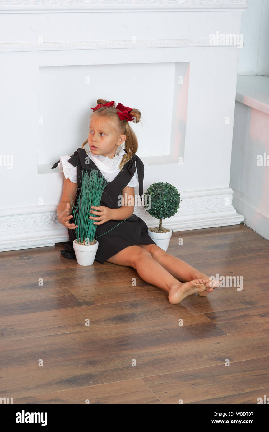 Portrait of beautiful young first-grader. First-grader girl in the ...