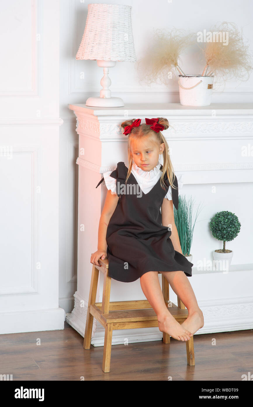 Portrait of beautiful young first-grader. First-grader girl in the ...