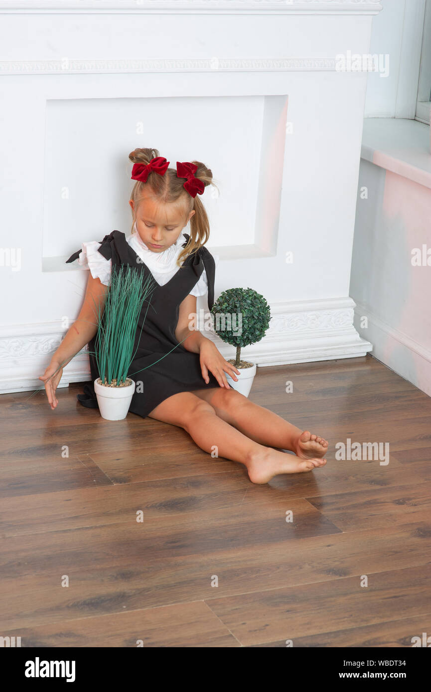 Portrait of beautiful young first-grader. First-grader girl in the ...