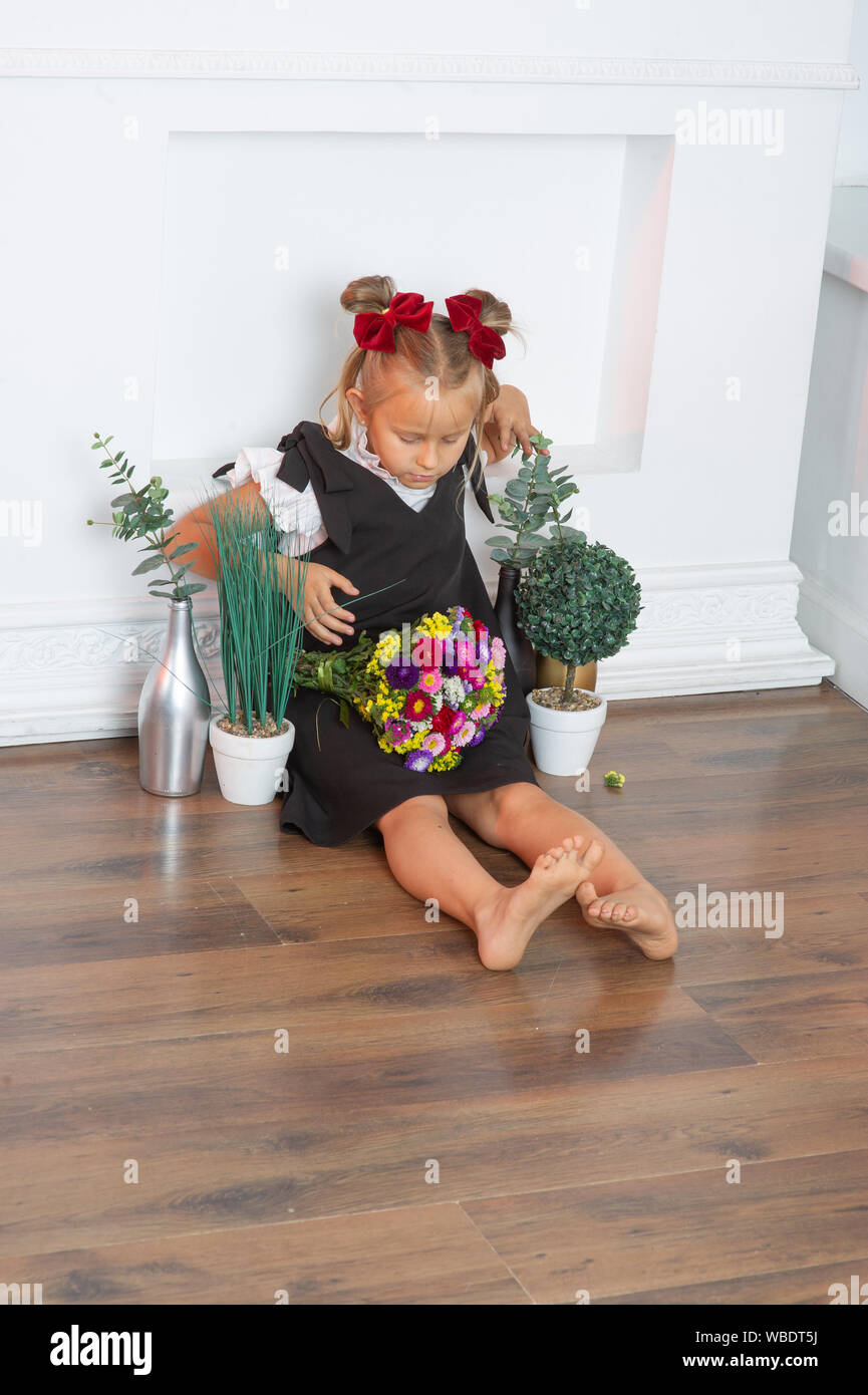 Portrait of beautiful young first-grader. First-grader girl in the ...