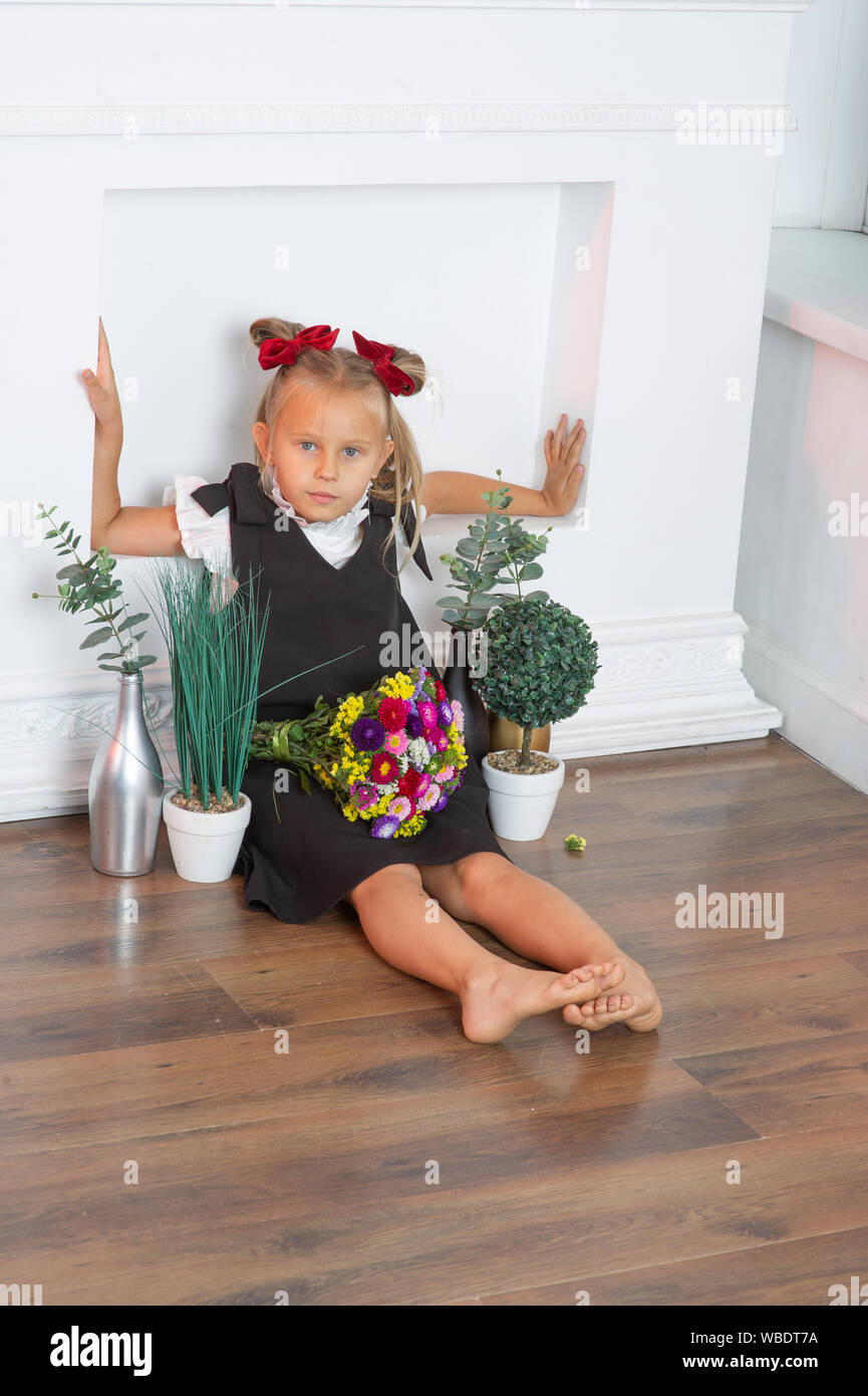 Portrait of beautiful young first-grader. First-grader girl in the ...