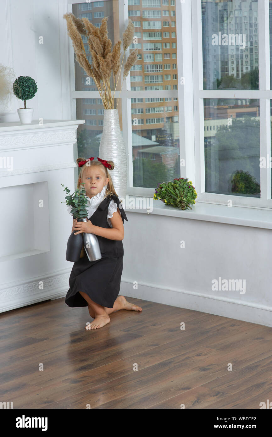 Portrait of beautiful young first-grader. First-grader girl in the ...