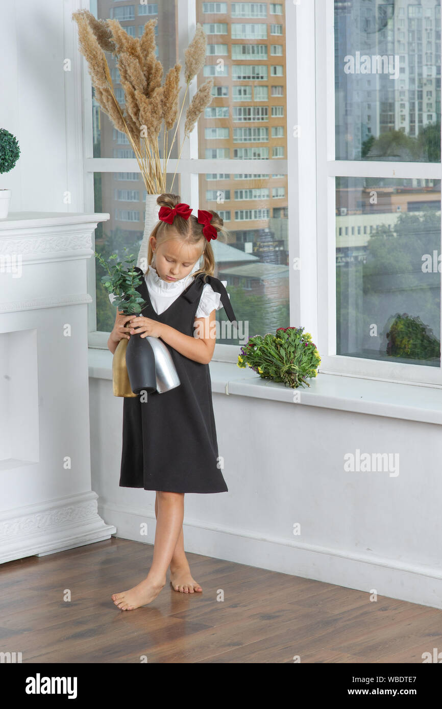 Portrait of beautiful young first-grader. First-grader girl in the ...