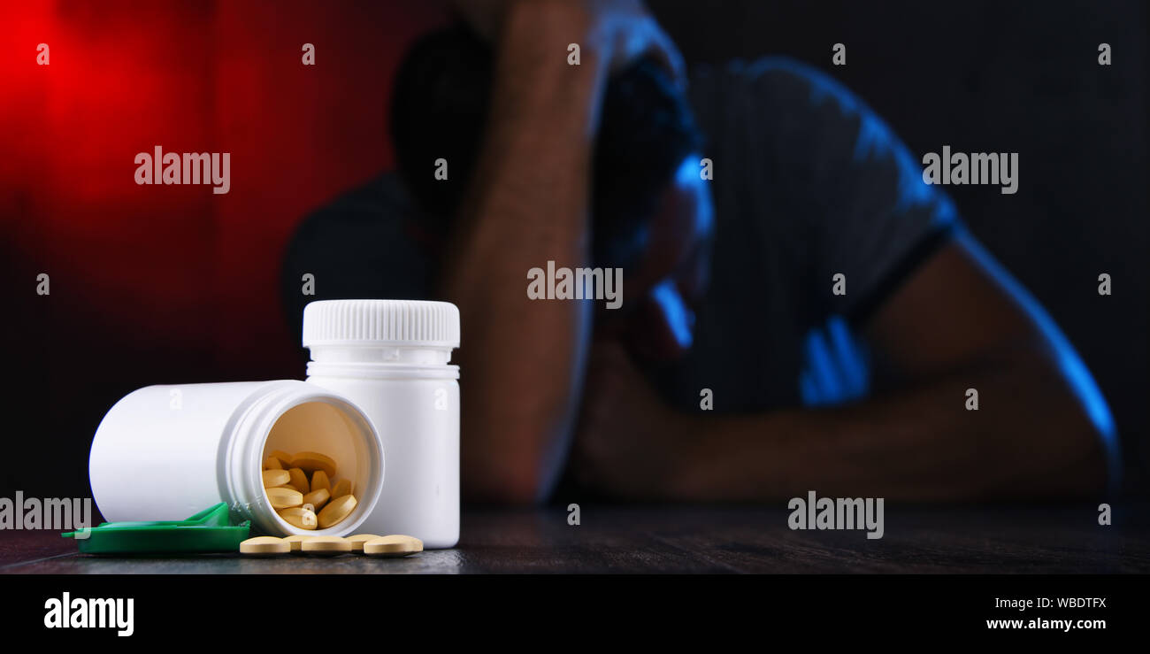 Drugs and the figure of a addicted man Stock Photo - Alamy