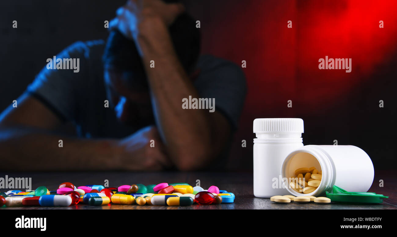 Drugs and the figure of a addicted man Stock Photo - Alamy