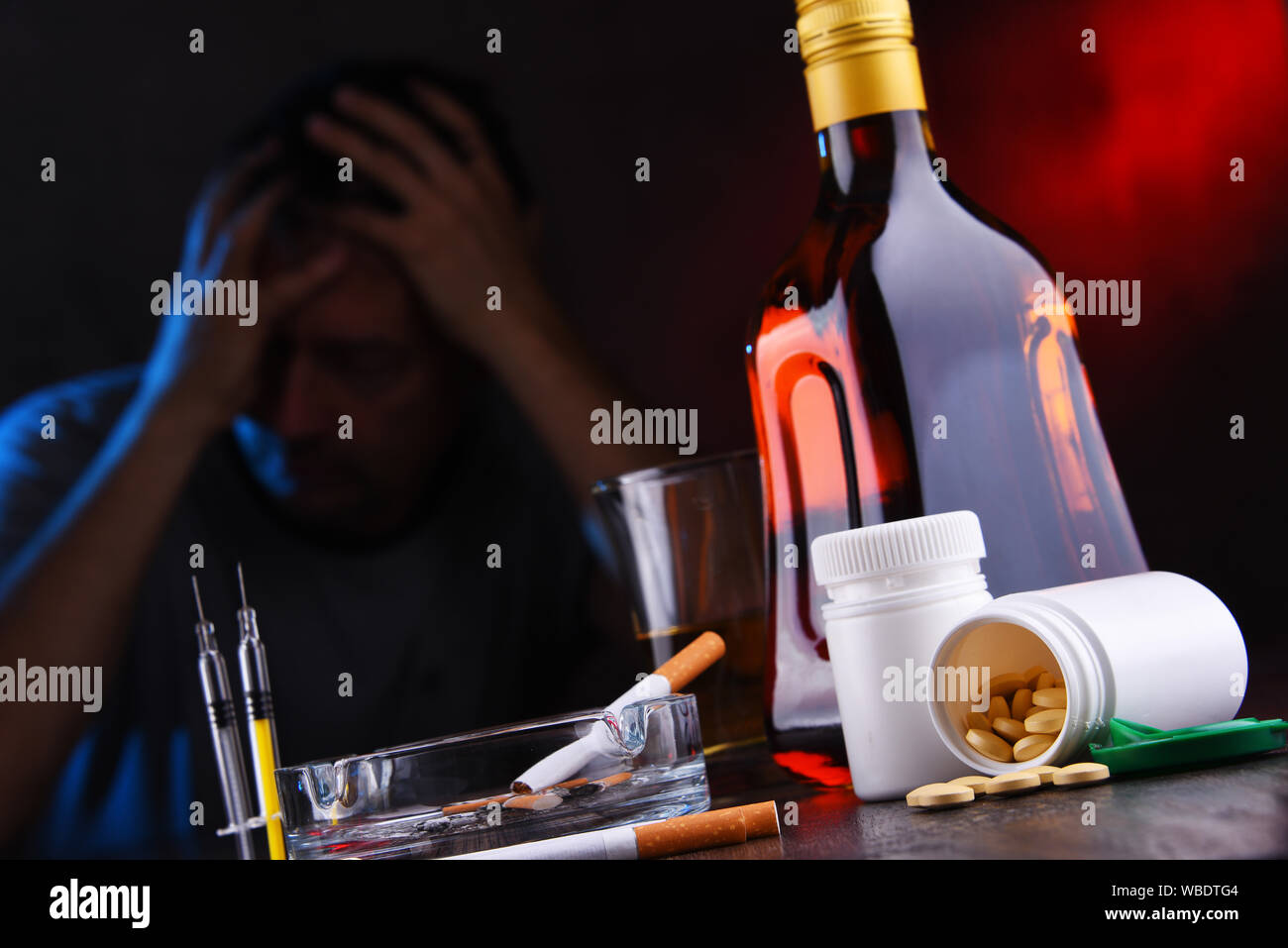 Addictive substances and the figure of a addicted man Stock Photo - Alamy