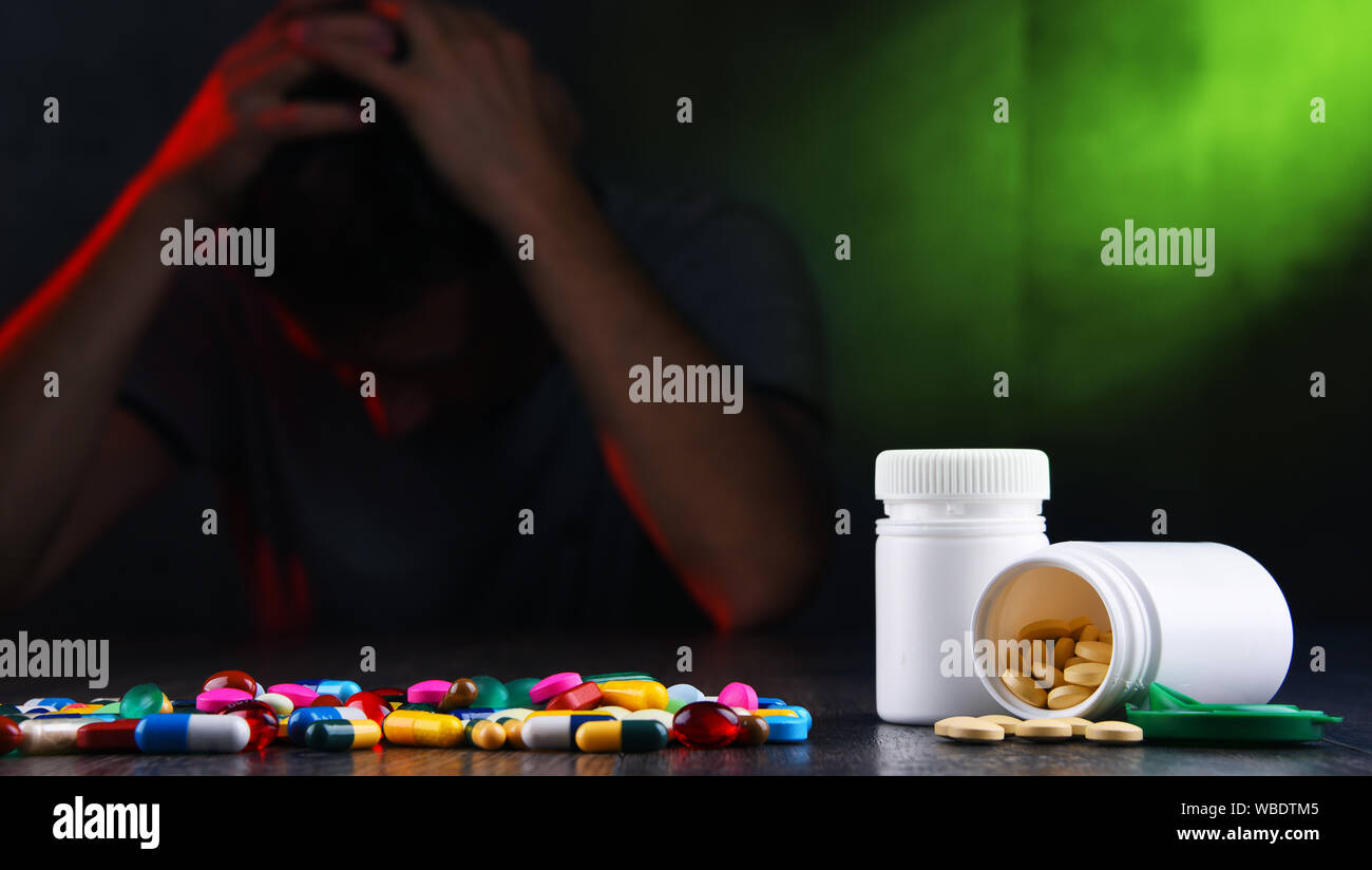 Drugs and the figure of a addicted man Stock Photo - Alamy