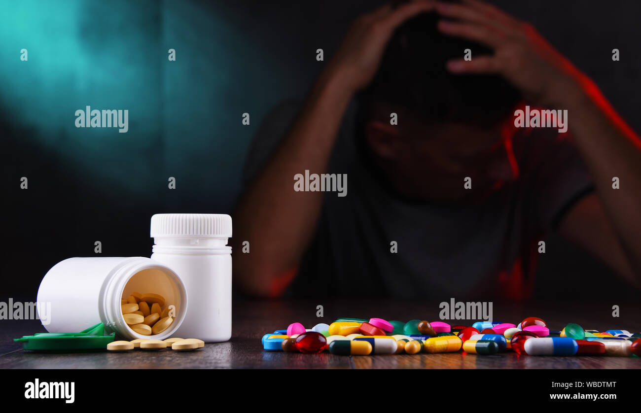 Drugs and the figure of a addicted man Stock Photo - Alamy