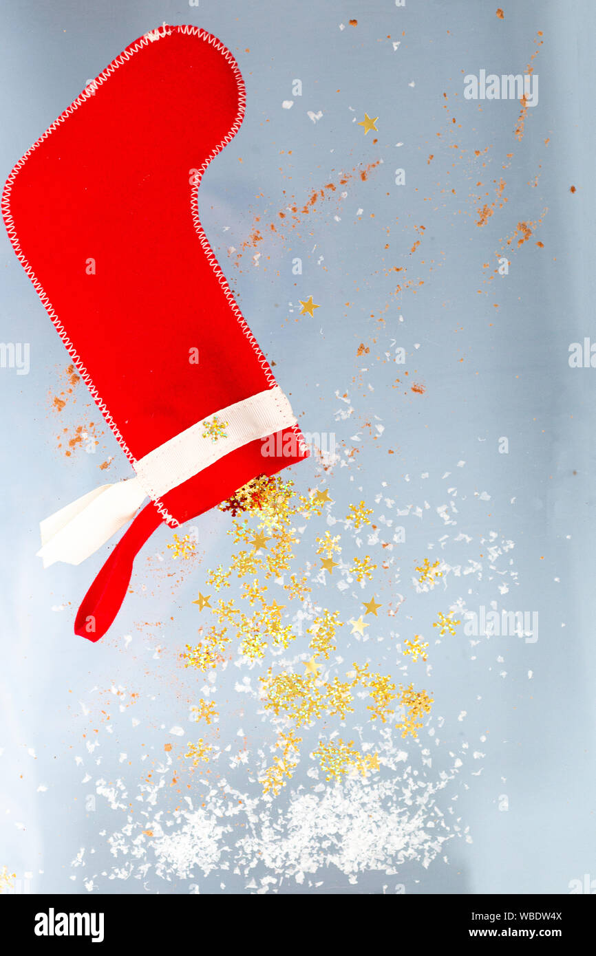 Shiny stars with snow are falling from a Santa Claus Christmas sock ...
