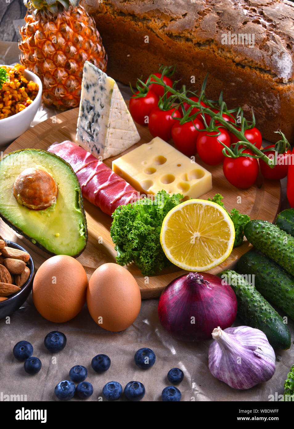Composition with assorted food products on kitchen table Stock Photo ...