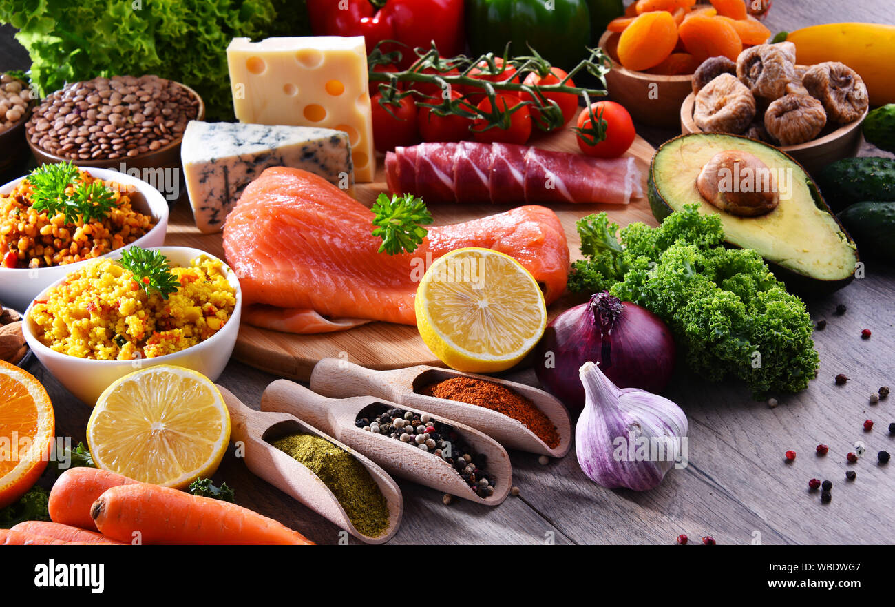 Composition with assorted food products on kitchen table Stock Photo ...