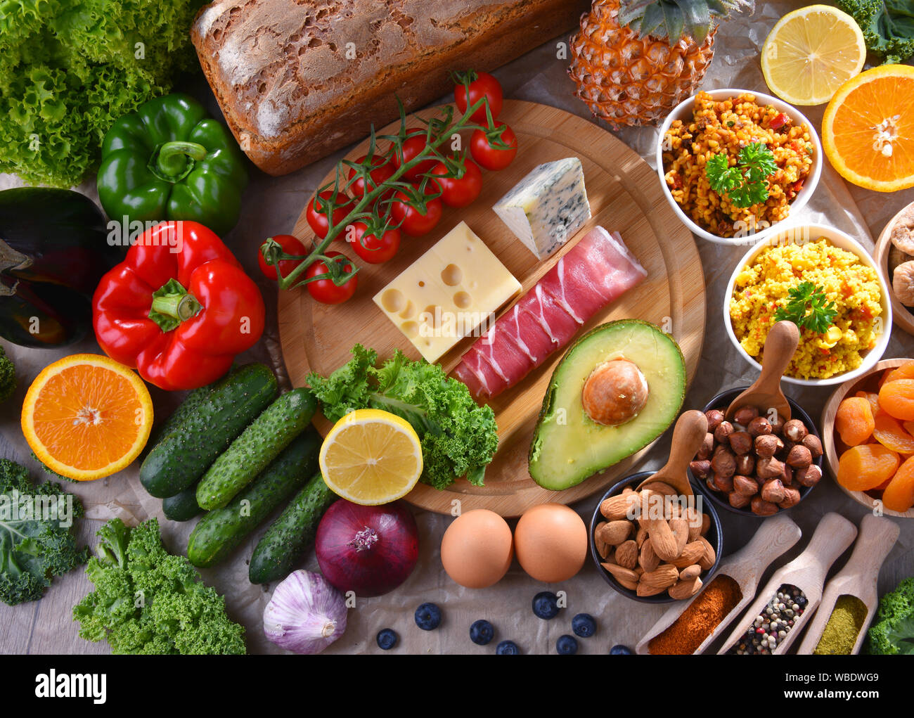 Composition with assorted food products on kitchen table Stock Photo ...