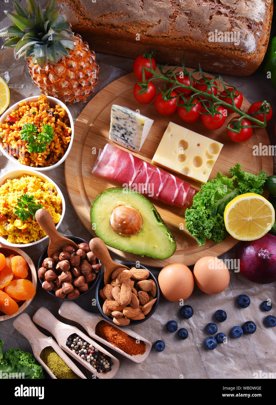 Composition with assorted food products on kitchen table Stock Photo ...