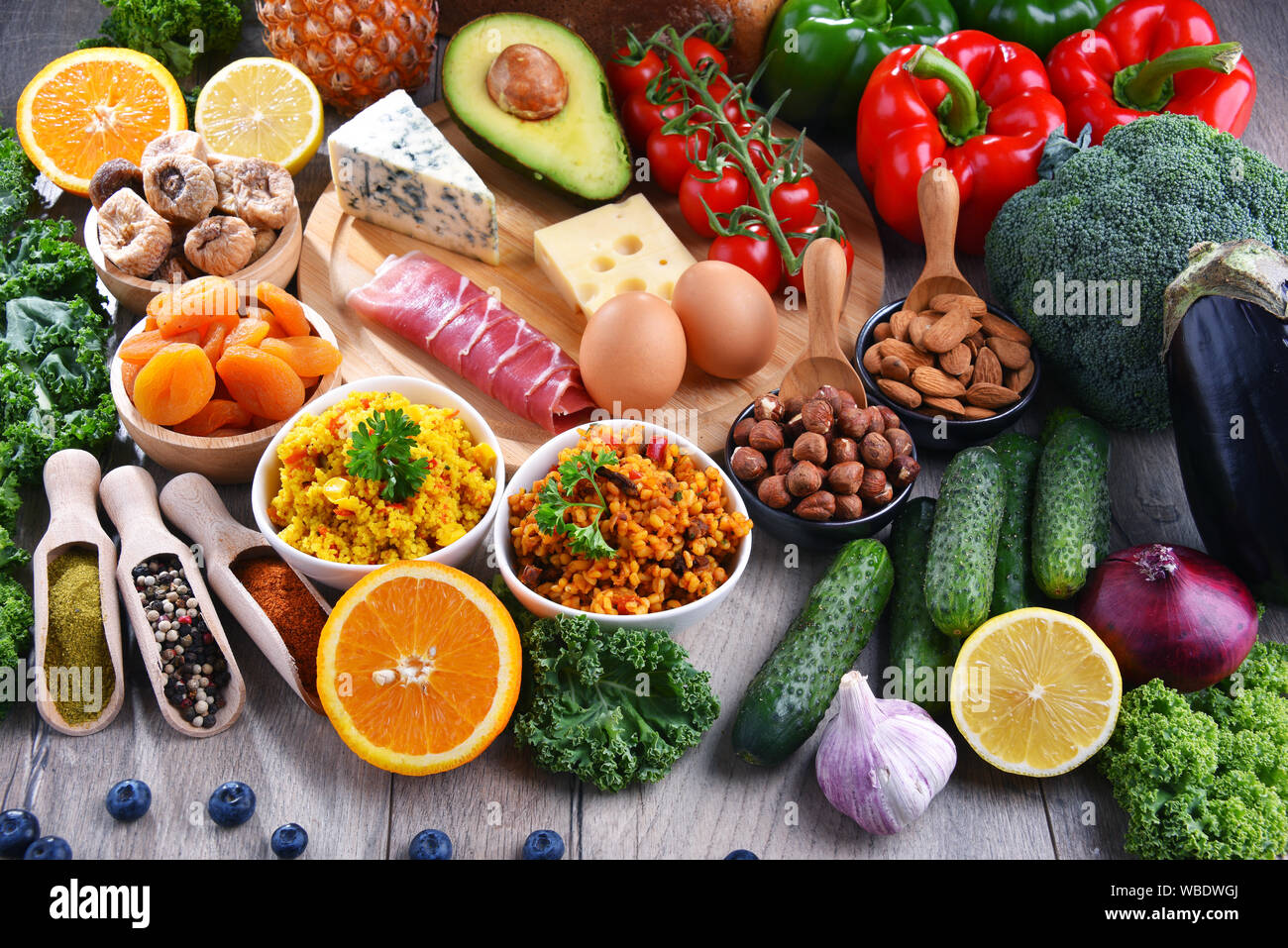 Composition with assorted food products on kitchen table Stock Photo ...